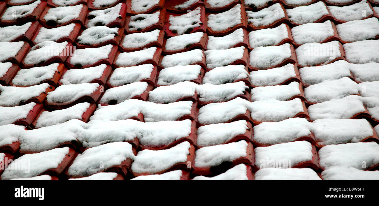 A tiled roof with thawing snow Stock Photo - Alamy