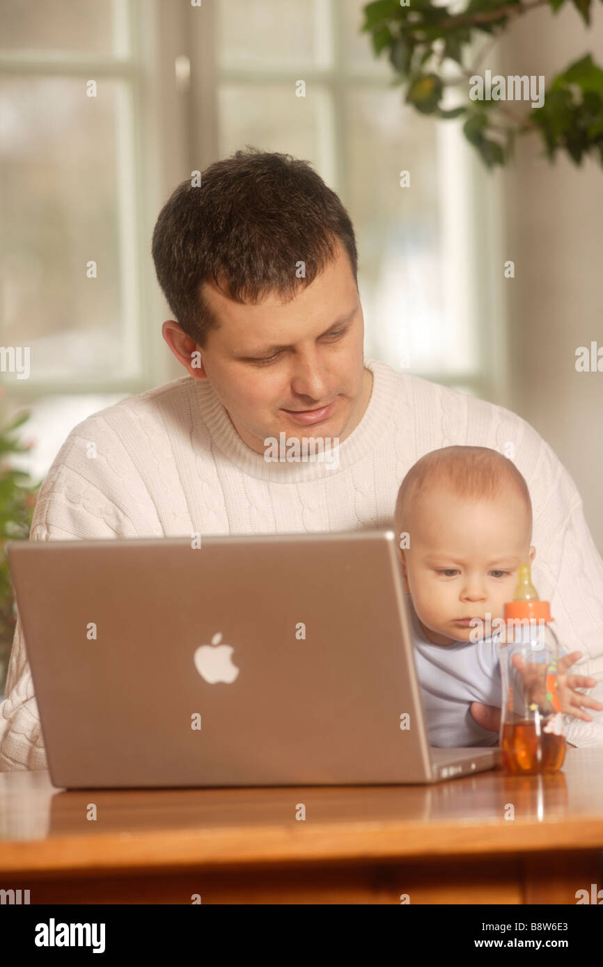 Son and Father Work with Laptop Stock Photo - Alamy