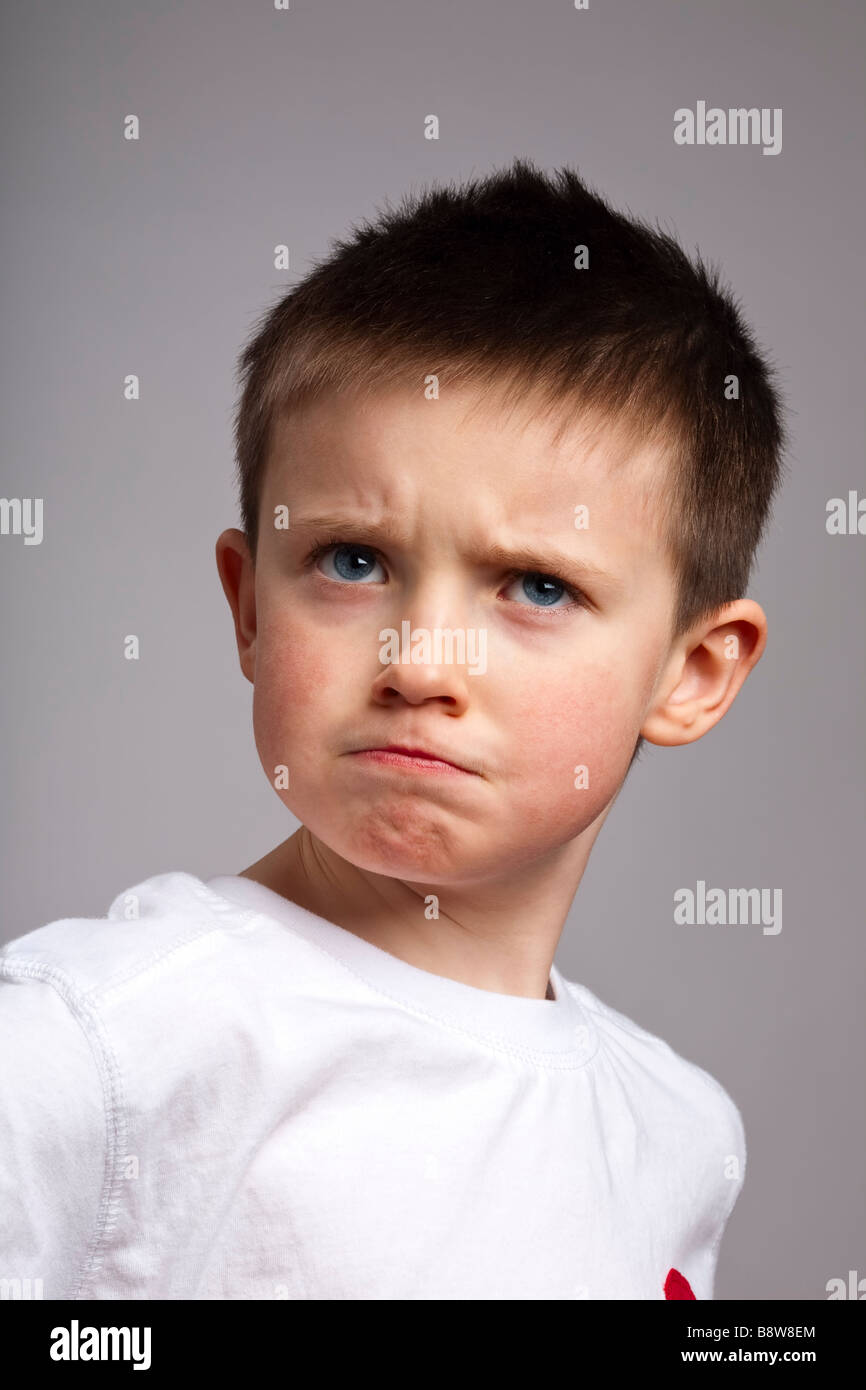 Portrait of little boy with angry expression Stock Photo - Alamy