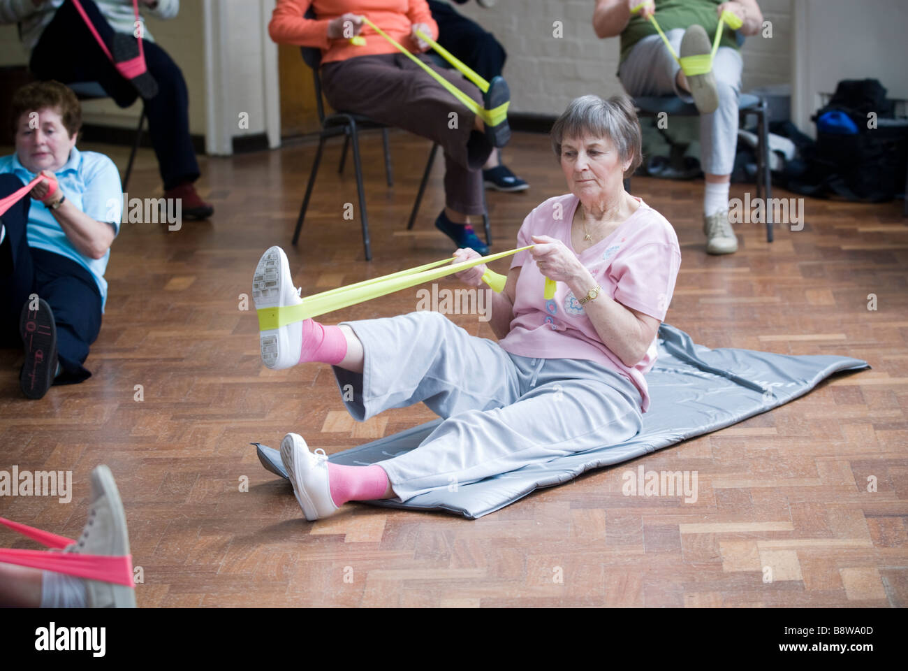 An elderly woman concentrates at a keep fit class Stock Photo - Alamy