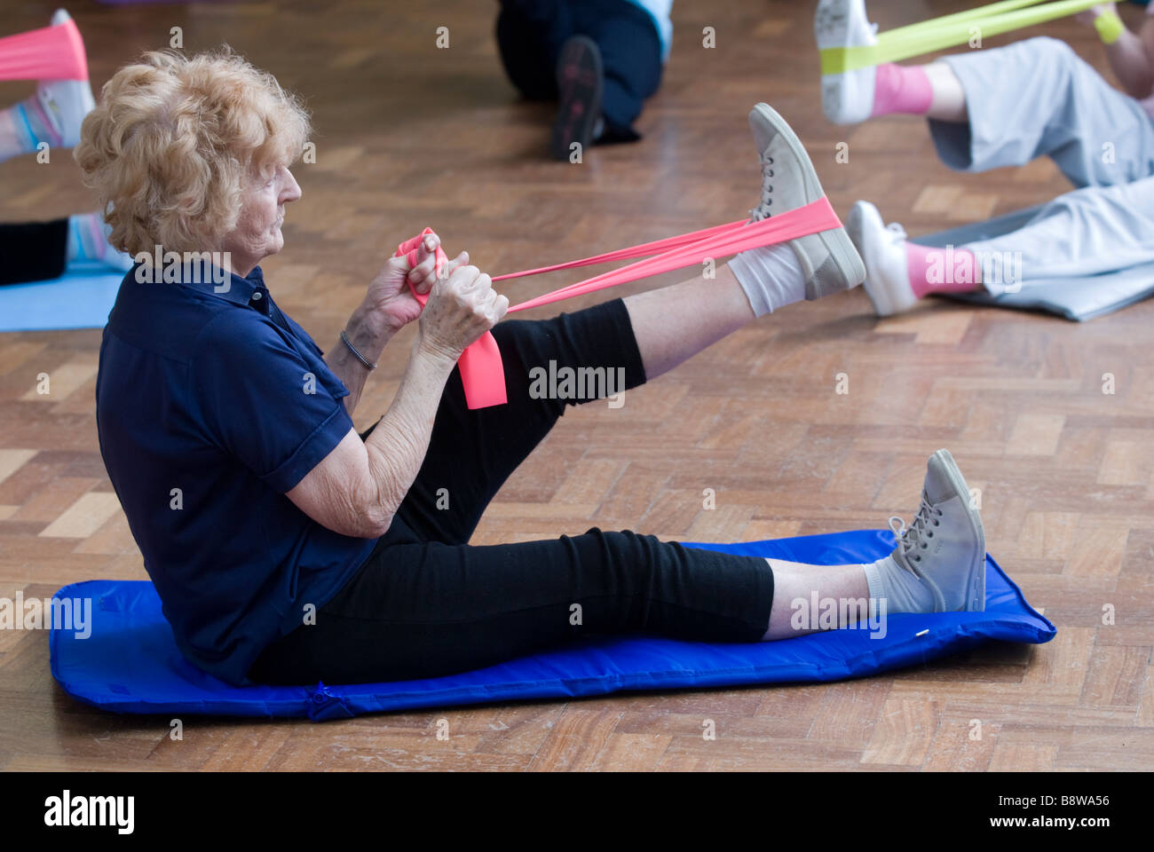 An elderly woman concentrates at a keep fit class Stock Photo - Alamy