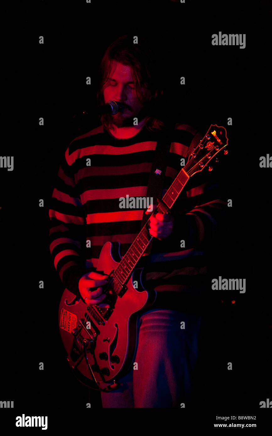 man playing guitar in rock band Stock Photo - Alamy