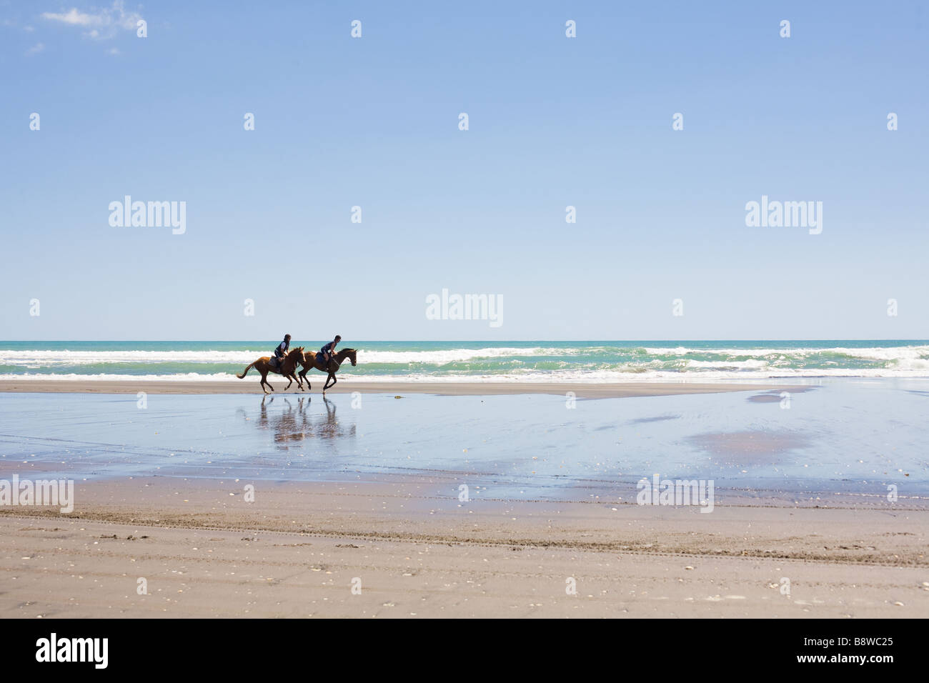 Horse Riders on Beach Stock Photo - Alamy