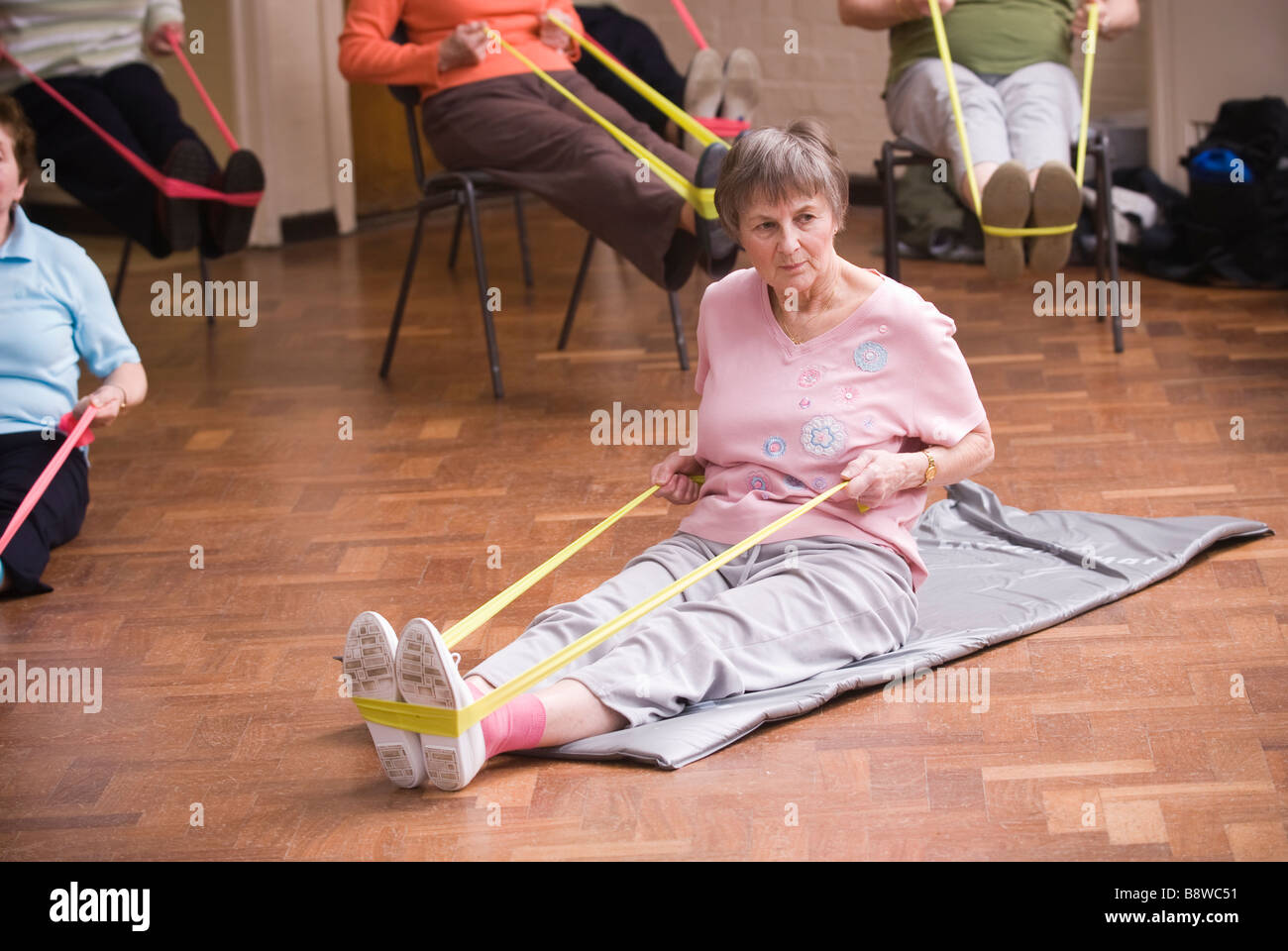 An elderly woman concentrates at a keep fit class Stock Photo - Alamy