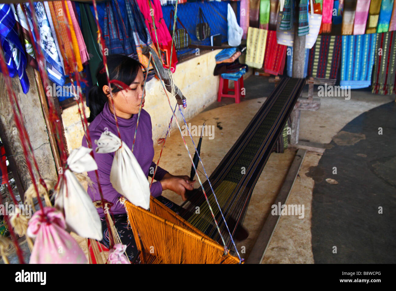 Asian People. Vietnamese woman weaving colourful scarf, carpet and ...