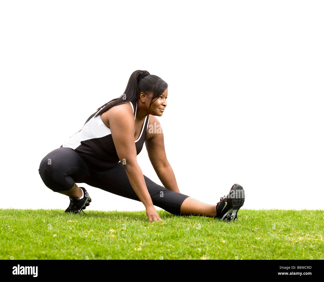 Plus size model in stretching position Stock Photo - Alamy