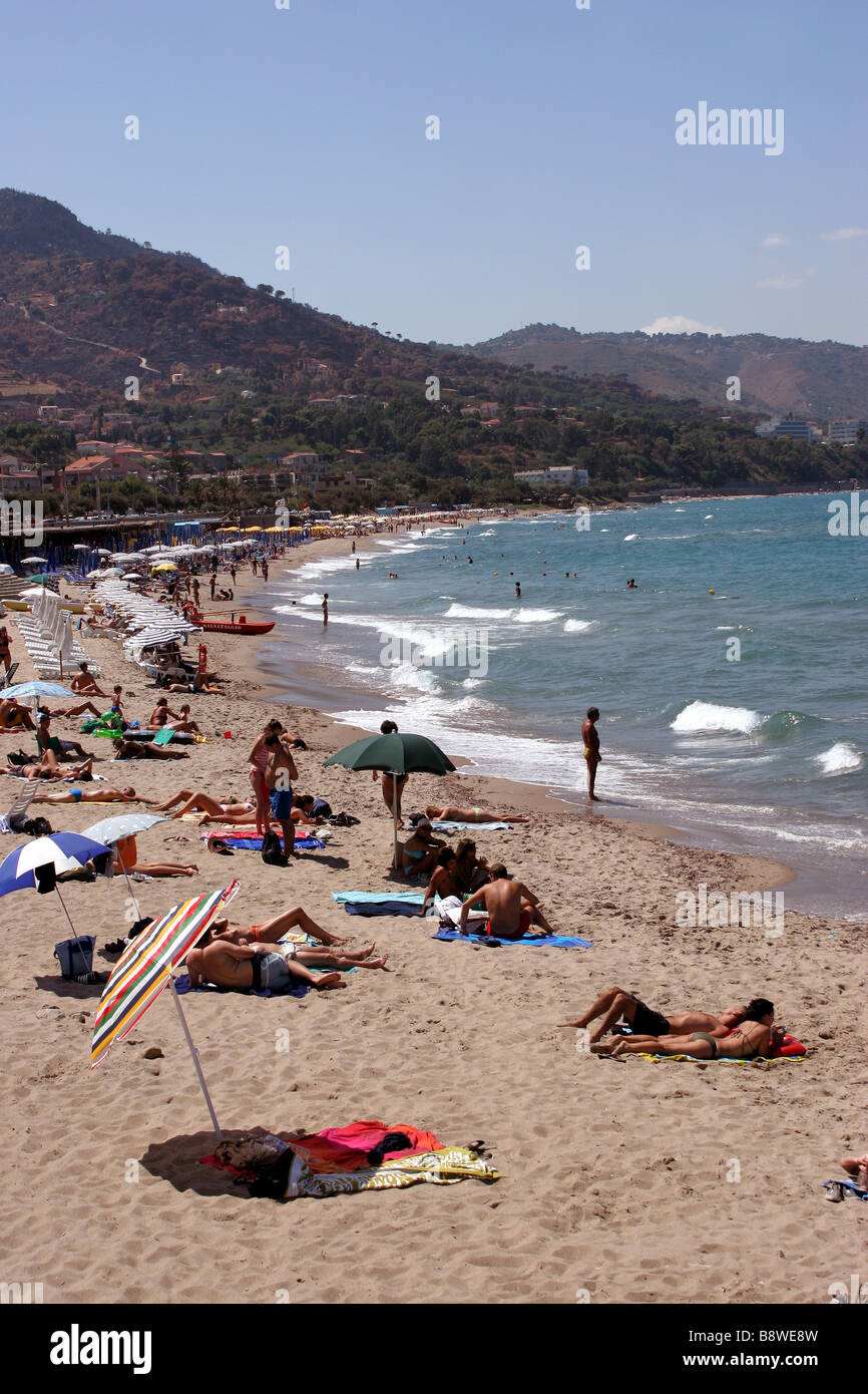 Sunbathers on a beach in Cefalu Sicily Stock Photo - Alamy