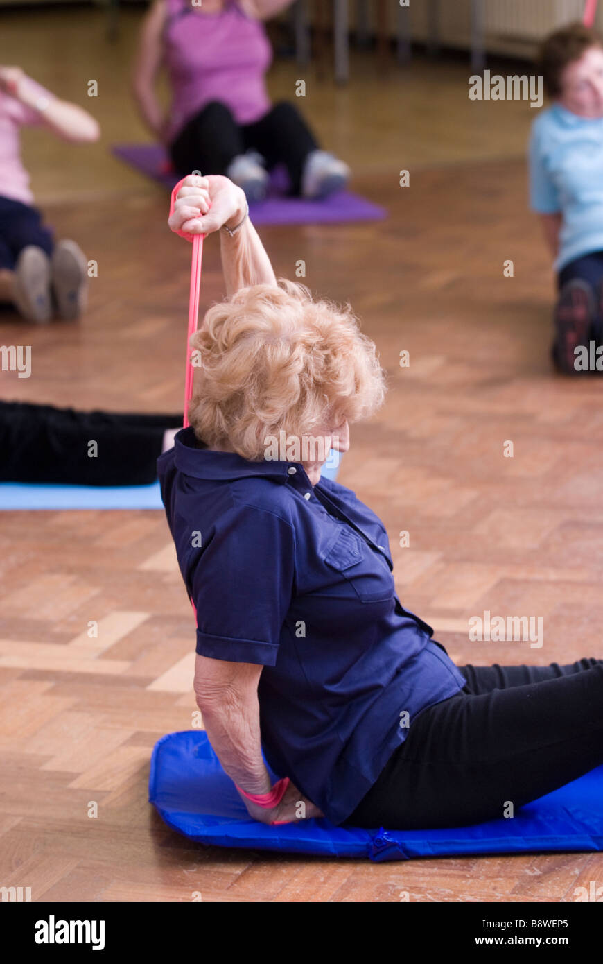 An elderly woman enjoys a keep fit class Stock Photo - Alamy