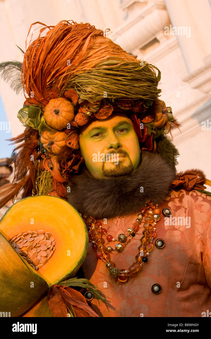 Venice Carnival. Man orange pumkin fruits hat Costume & mask, sunset ...