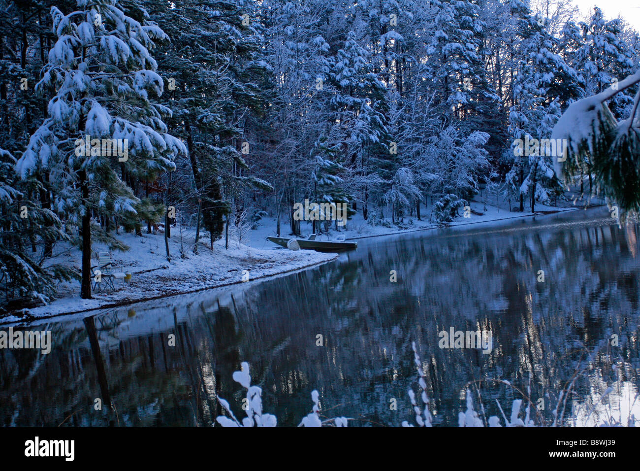 Boat on a snowy pond Stock Photo - Alamy
