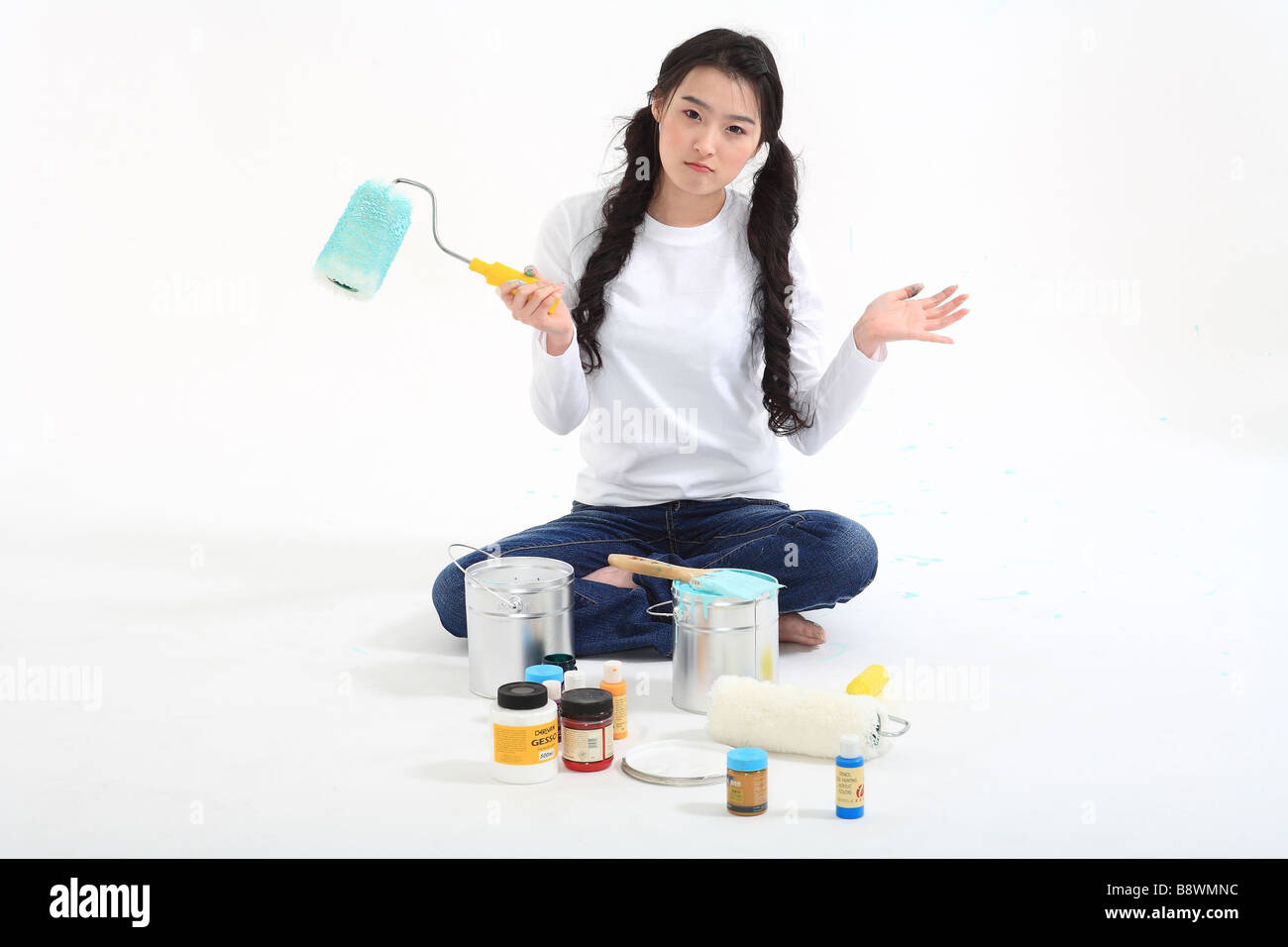 Woman thinking paint roller hi-res stock photography and images - Alamy