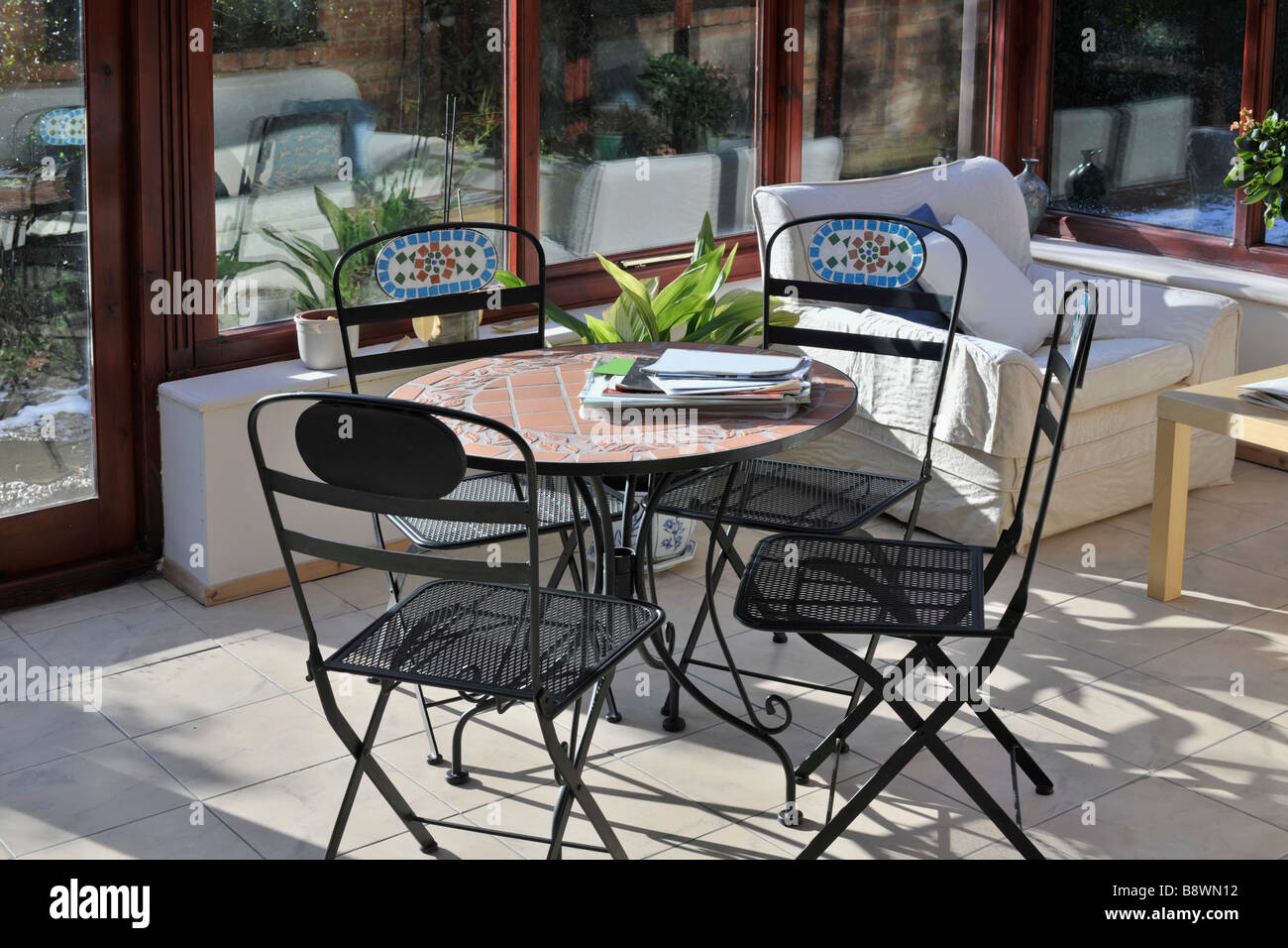 conservatory tables chairs plants room in house next to garden Stock ...