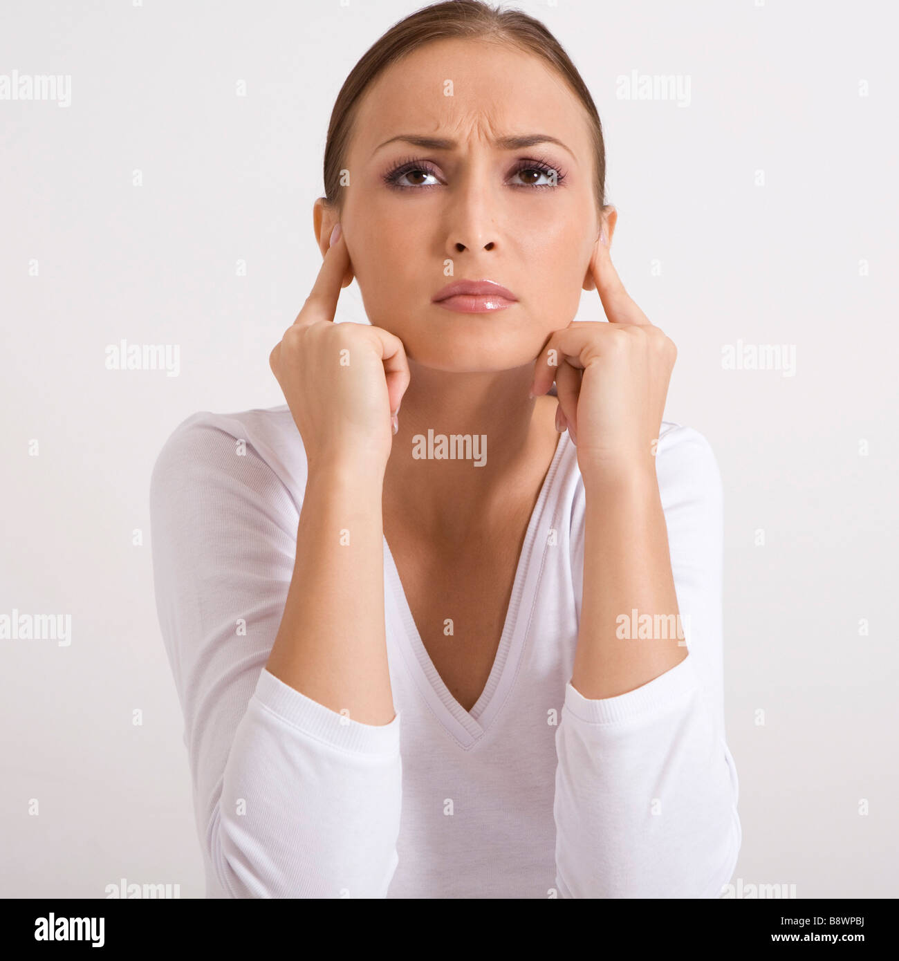 young woman covering her ears Stock Photo - Alamy