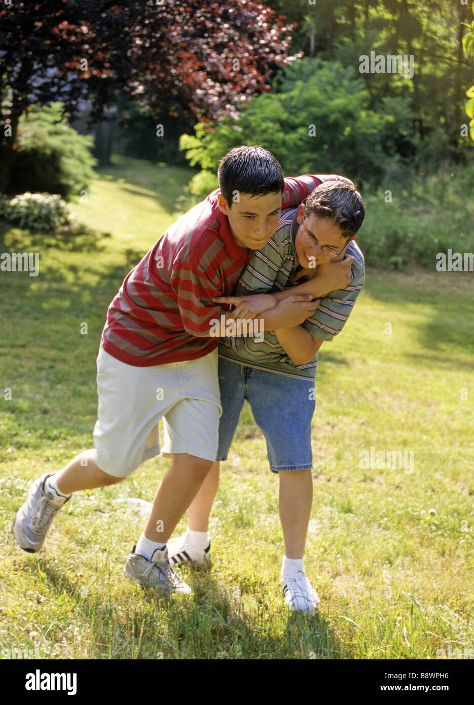 Friend playfully fighting Stock Photo - Alamy