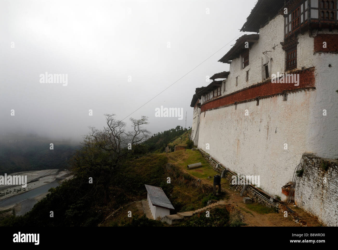 The whitewashed stone walls of Wangdue Phrodrang Dzong loom above the ...