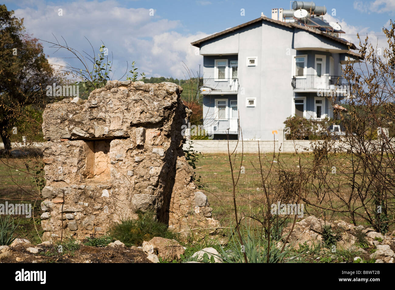 old rough stonework and new Turkish apartment block at Hisaronu near ...