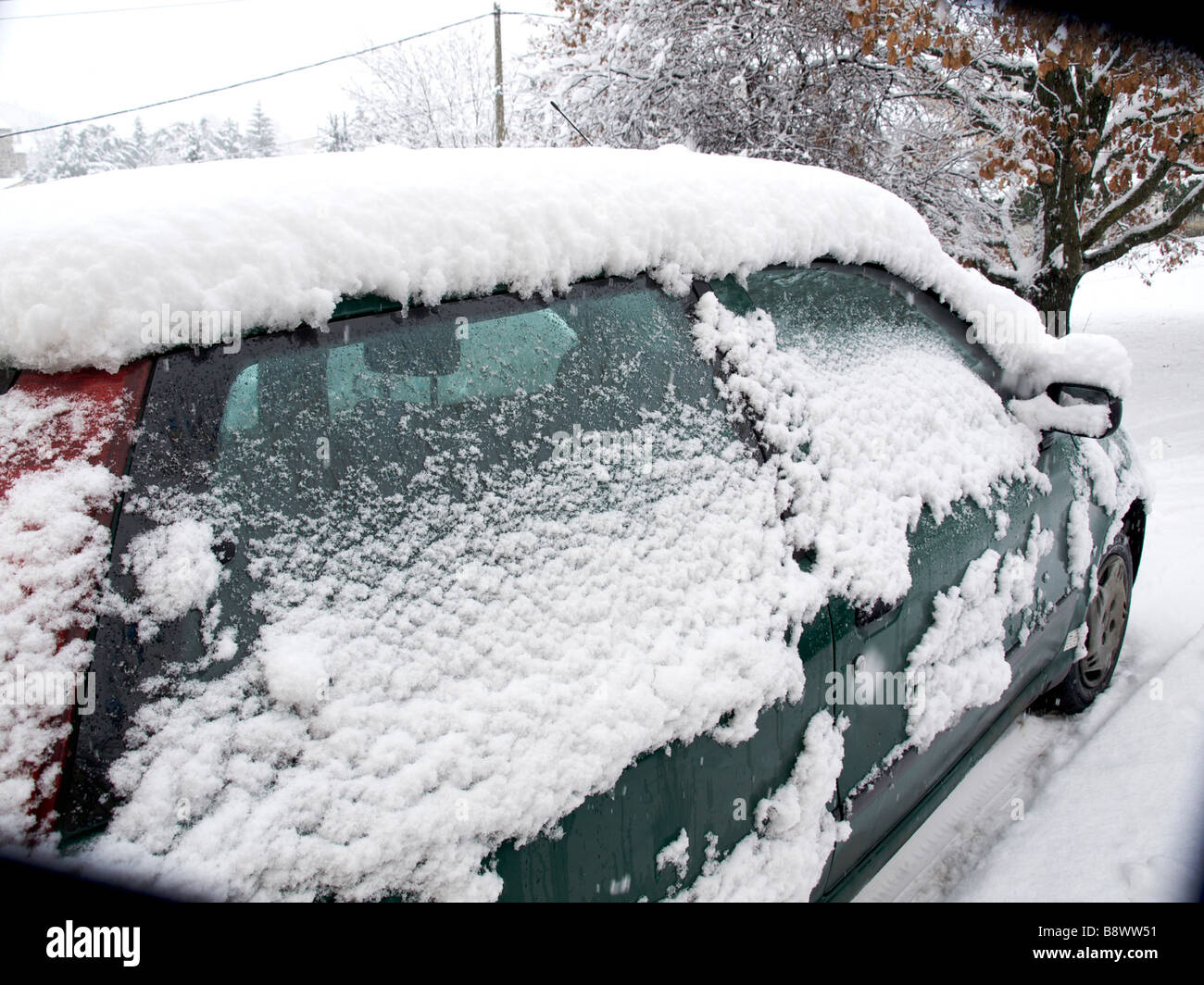 Car covered in snow on a road Stock Photo - Alamy