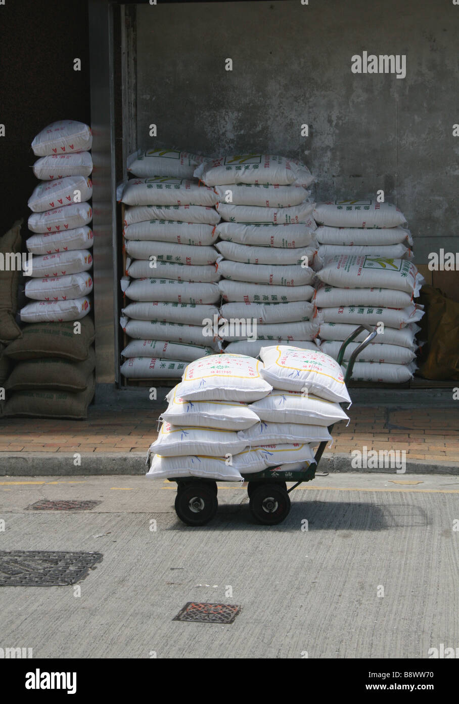stacks of sacks of rice and hand cart Hong Kong April 2008 Stock Photo ...