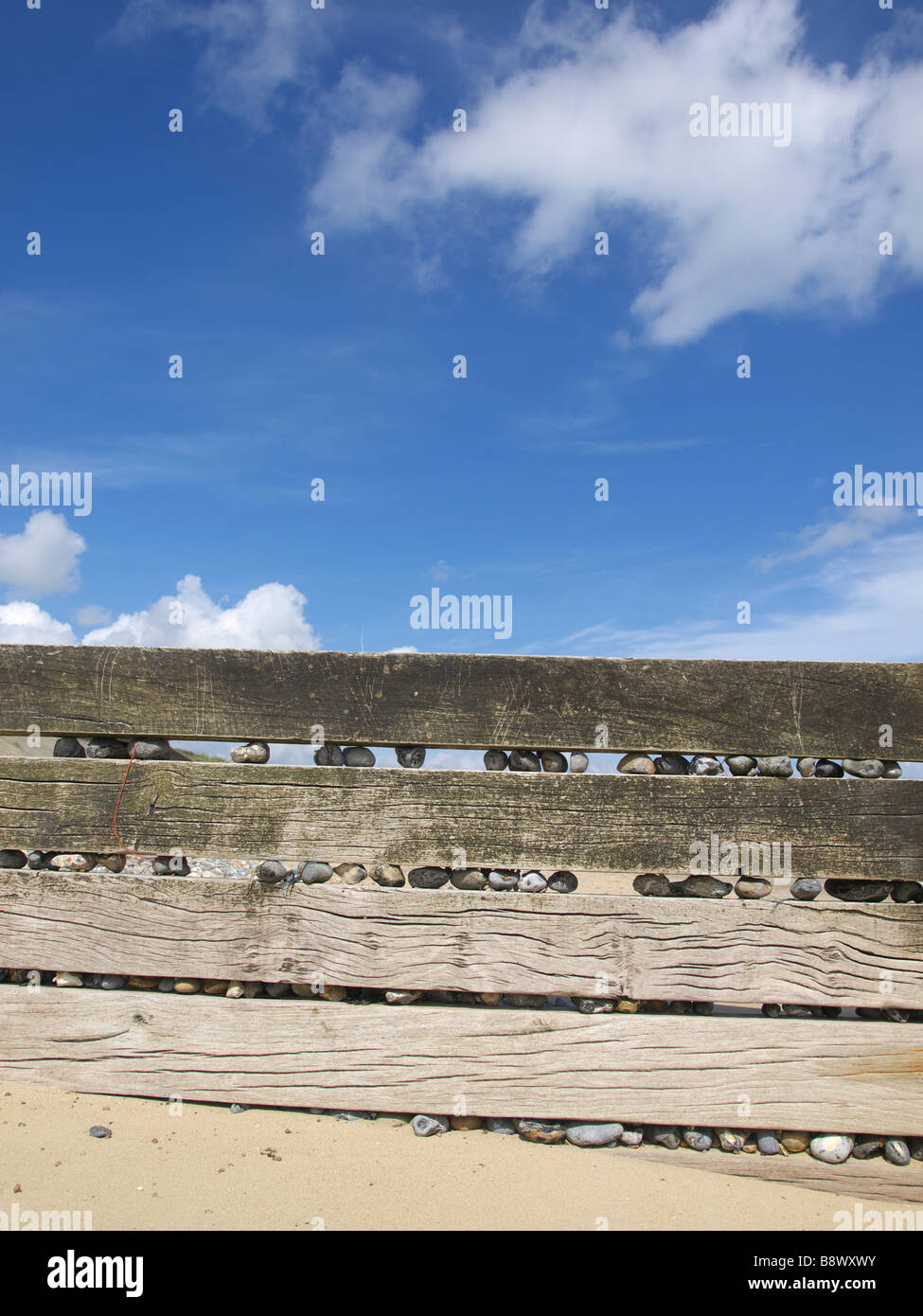 Beach groyne with stones and sky Stock Photo - Alamy