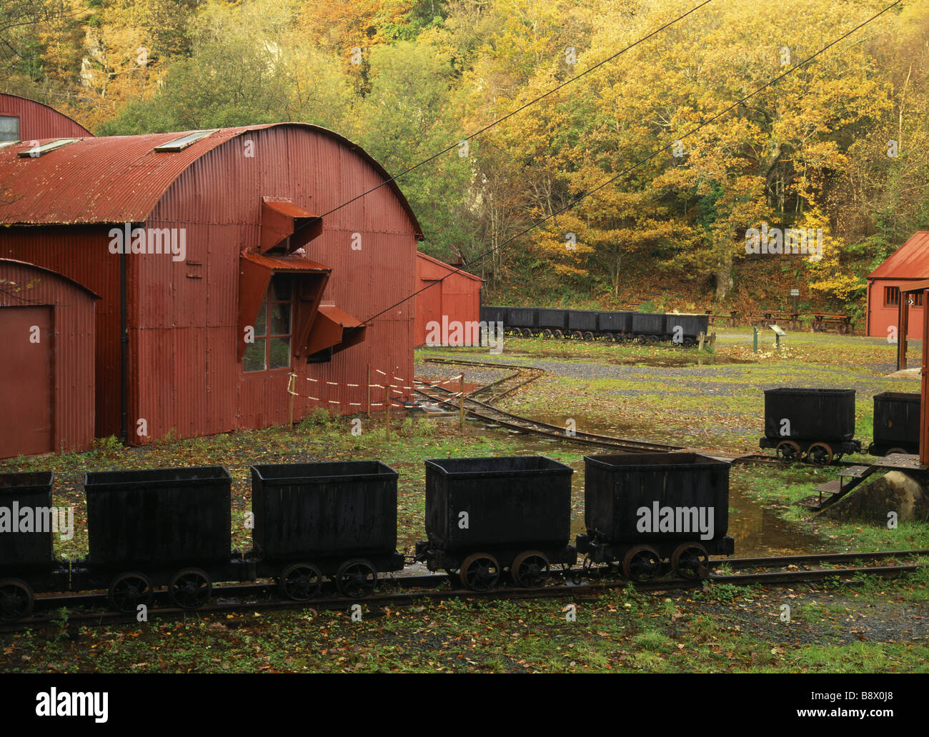 The corrugated iron buildings at the Gold Mine with several trucks ...