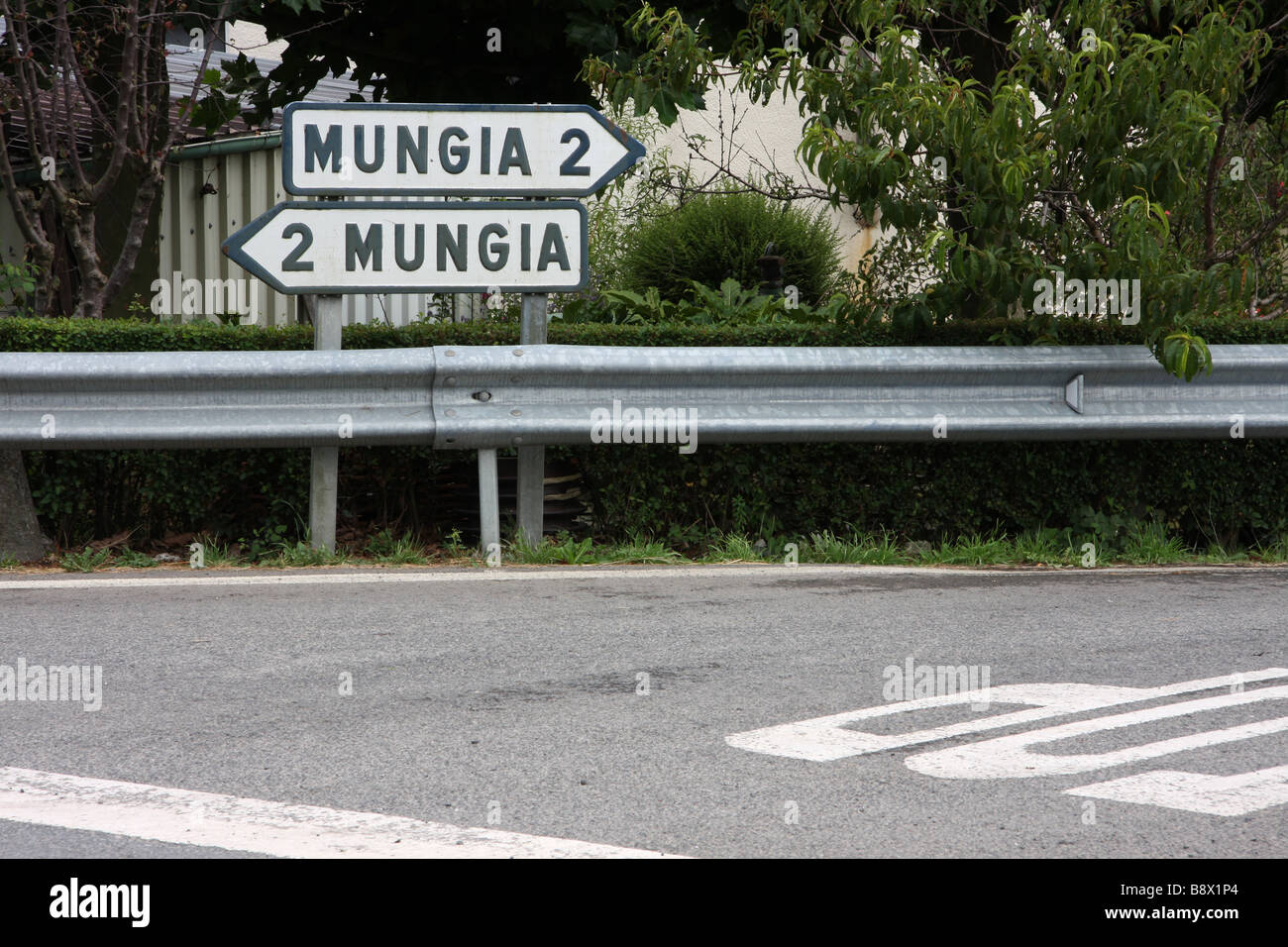 Two road signs pointing in different directions to the same destination ...