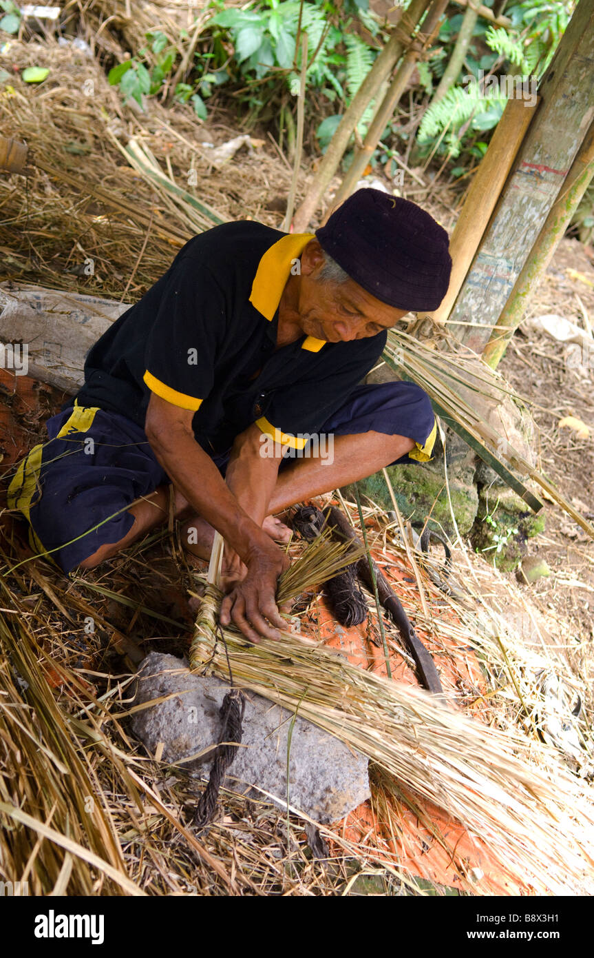 Balinese man making thatch from dried grass, Ubud,Bali,Indonesia Stock ...