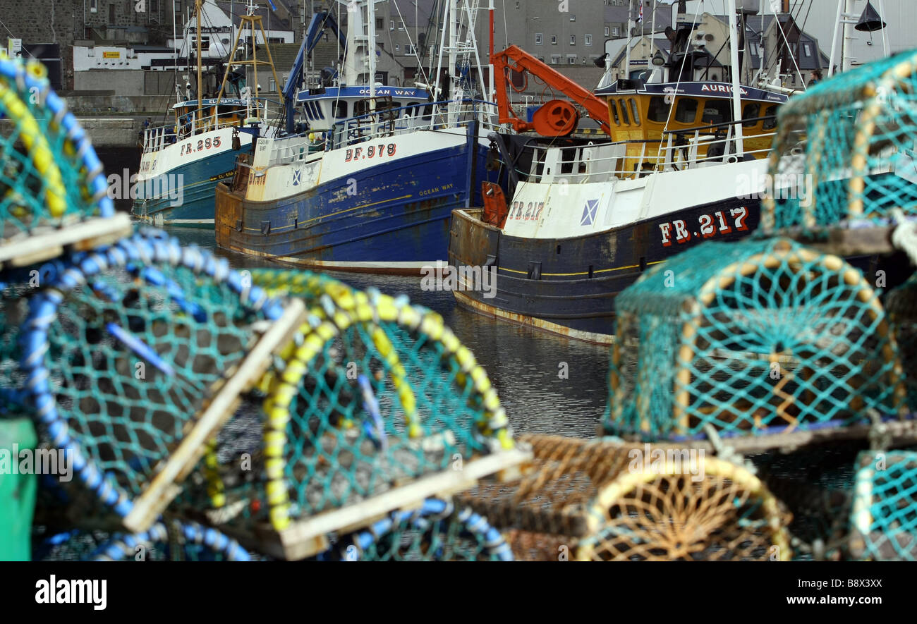 Lobster and crab pots line the shore at Peterhead Harbour, Scotland, UK ...