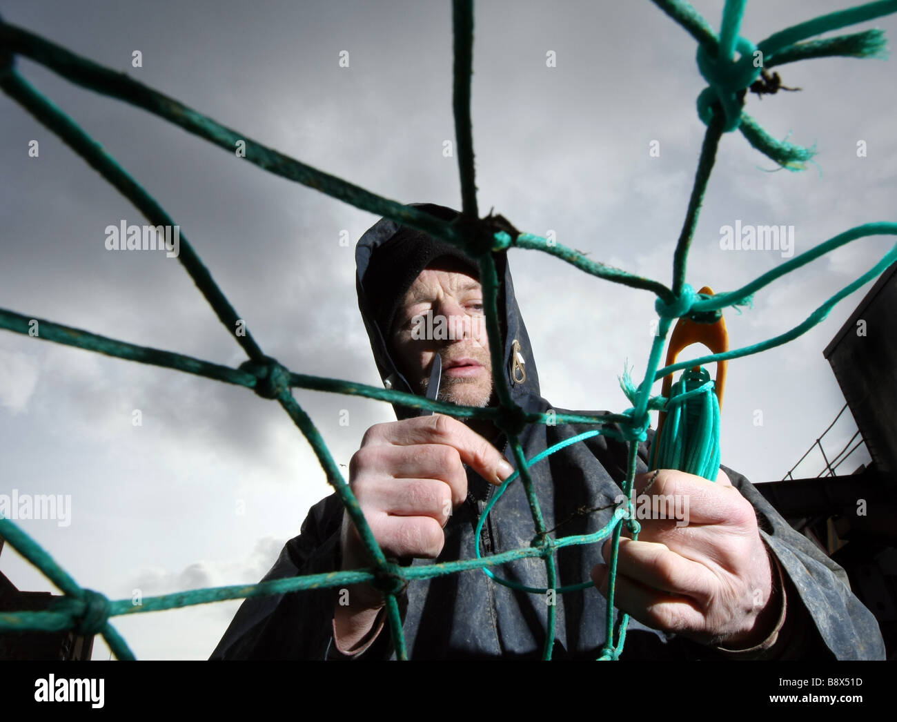 Mending nets holes hi-res stock photography and images - Alamy