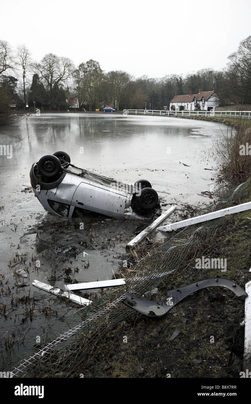 car crash and overturned in frozen pond UK Stock Photo - Alamy