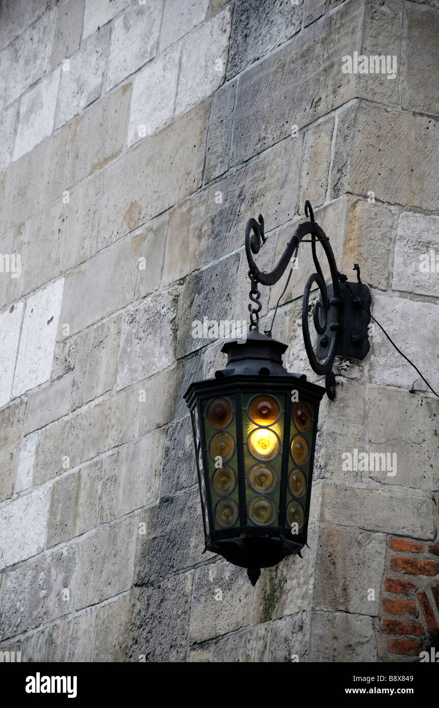 rustic old street light lamp lit illuminat illuminated building wall ...