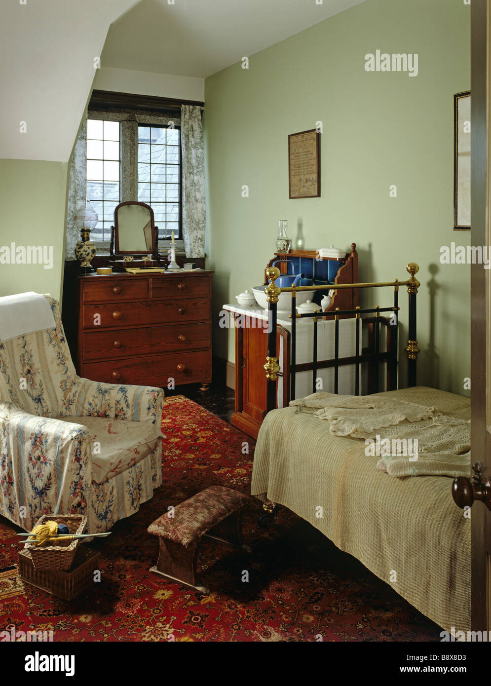 The servants bedroom at Lanhydrock Bed with brass bedstead and knitting ...