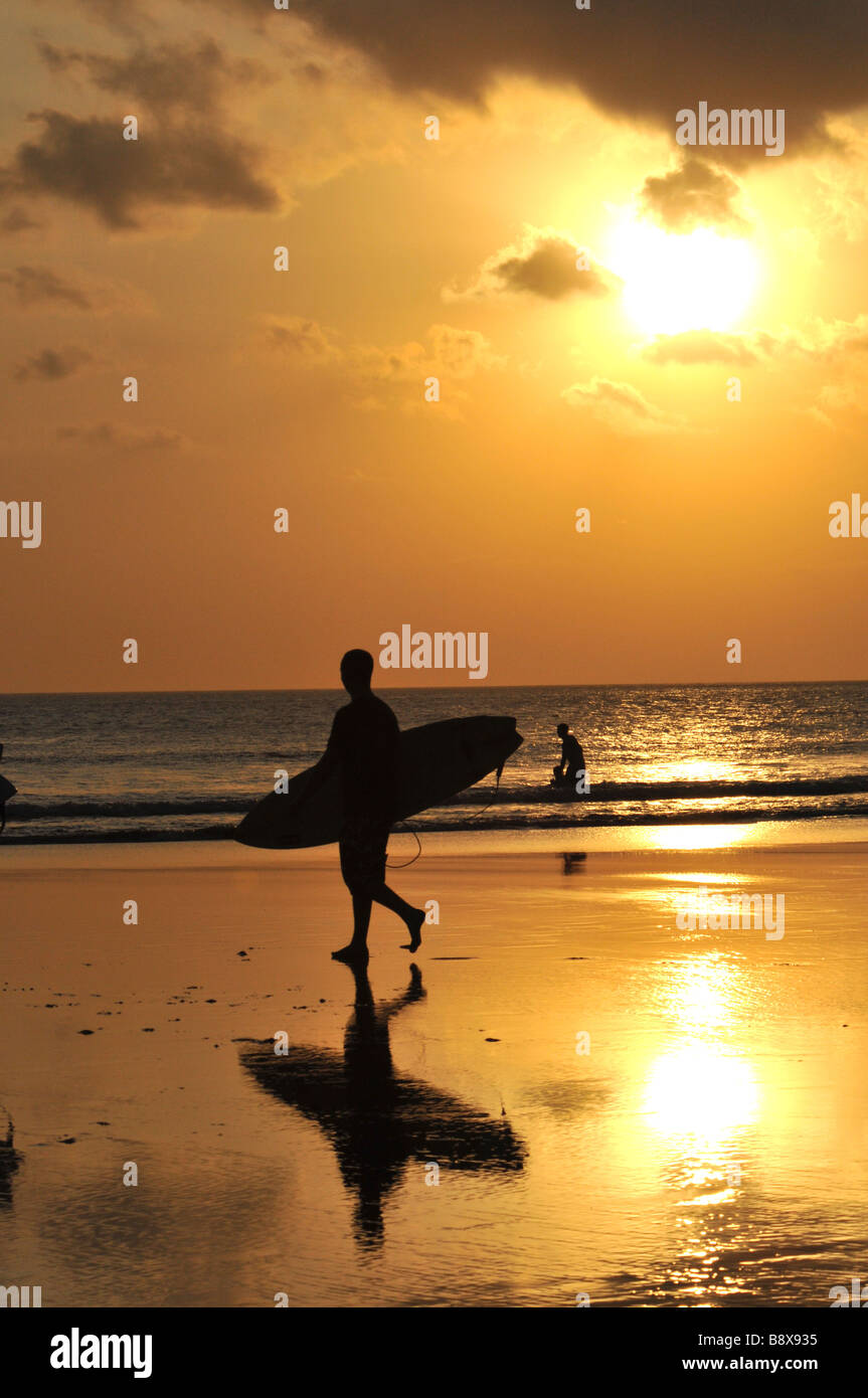 Surfer walking at sunset,Kuta beach,Bali,Indonesia Stock Photo - Alamy