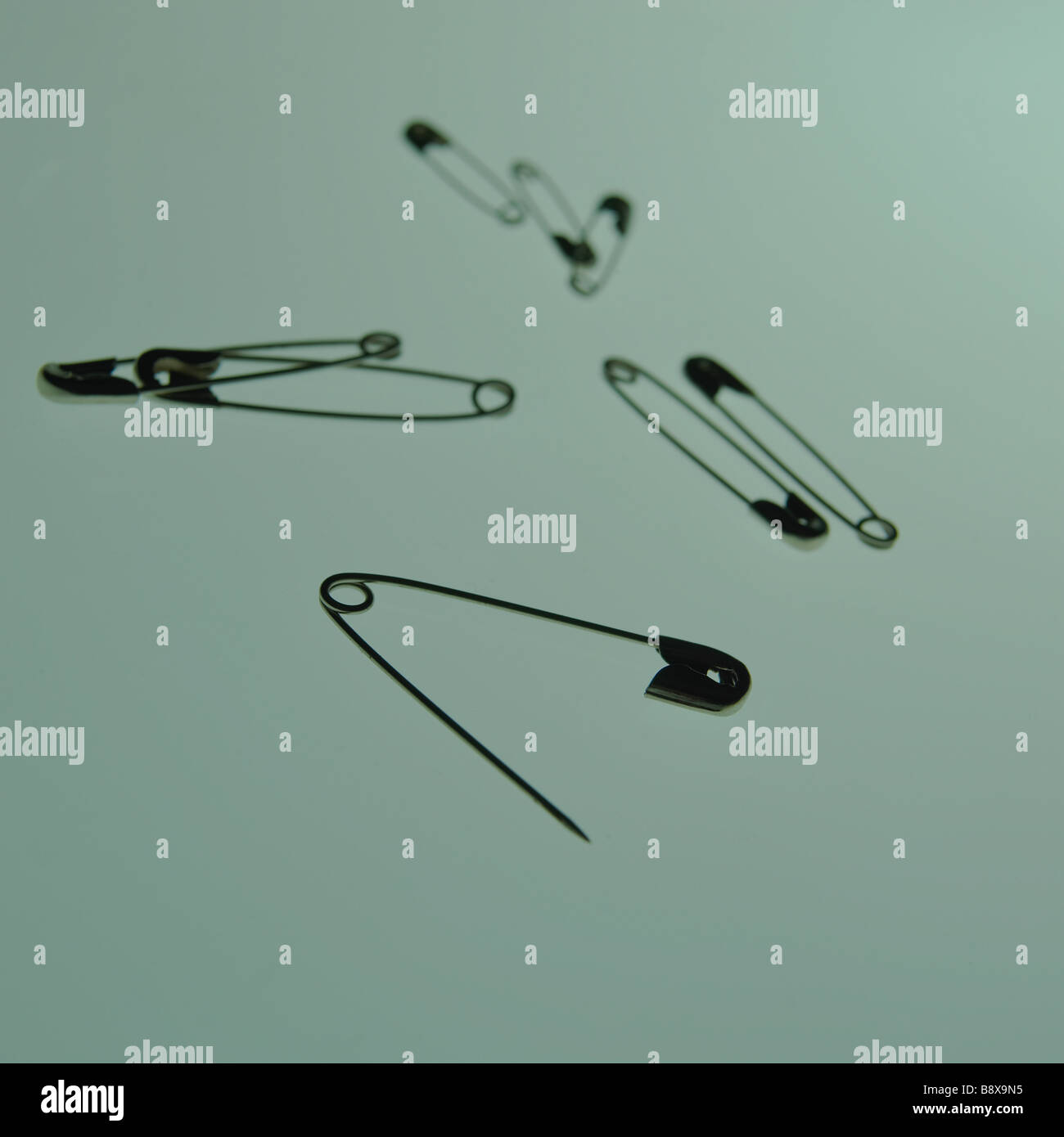 A contemporary set of different sized safety pins Stock Photo - Alamy