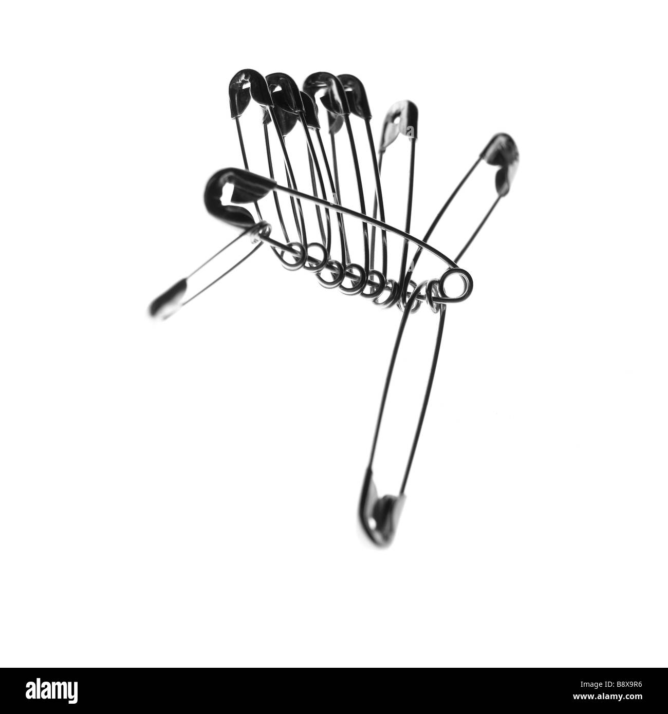 A contemporary set of different sized safety pins Stock Photo - Alamy