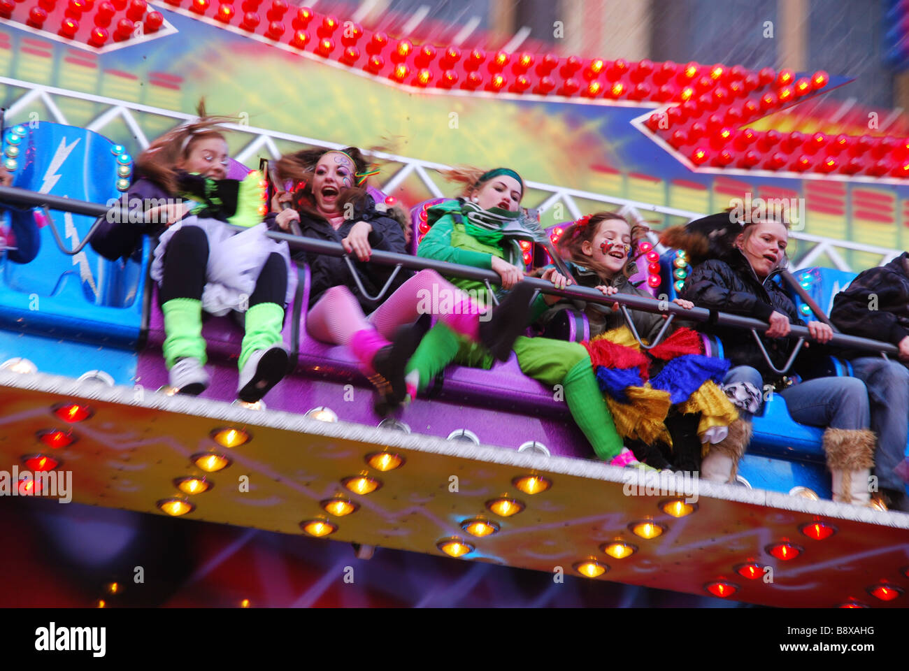 screaming girls in fairground attraction at full swing Stock Photo - Alamy