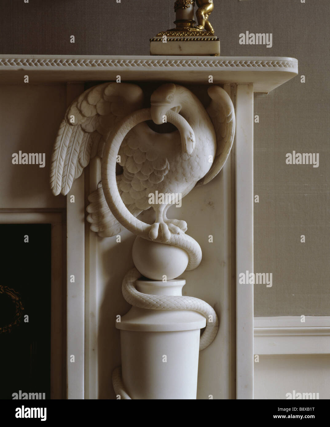 Detail of a white marble fireplace featuring an eagle and snake in the ...