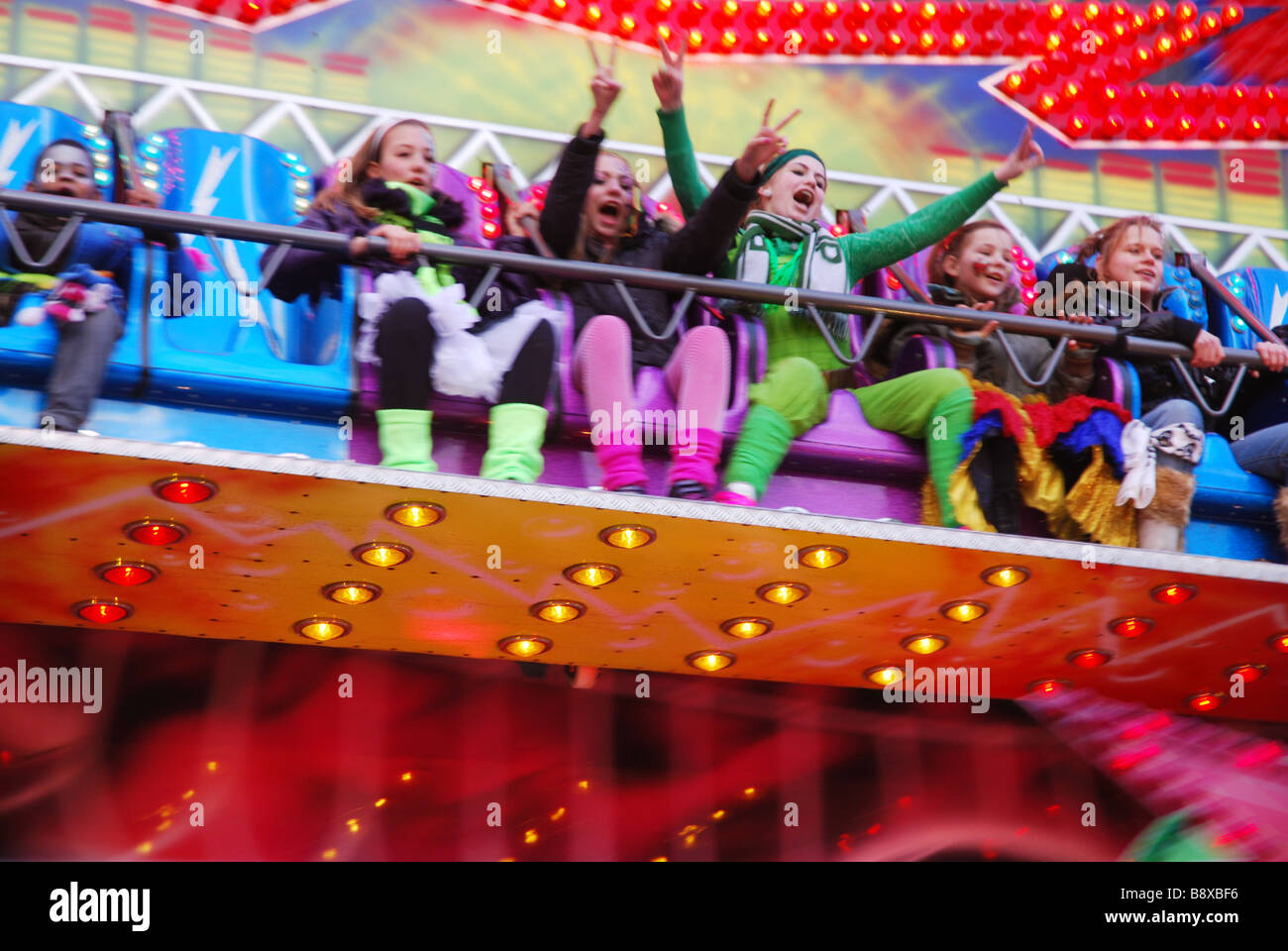 screaming girls in fairground attraction at full swing Stock Photo - Alamy