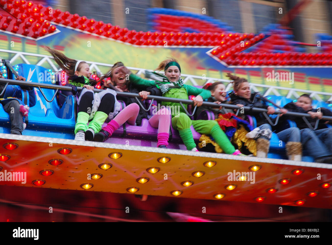 screaming girls in fairground attraction at full swing Stock Photo - Alamy