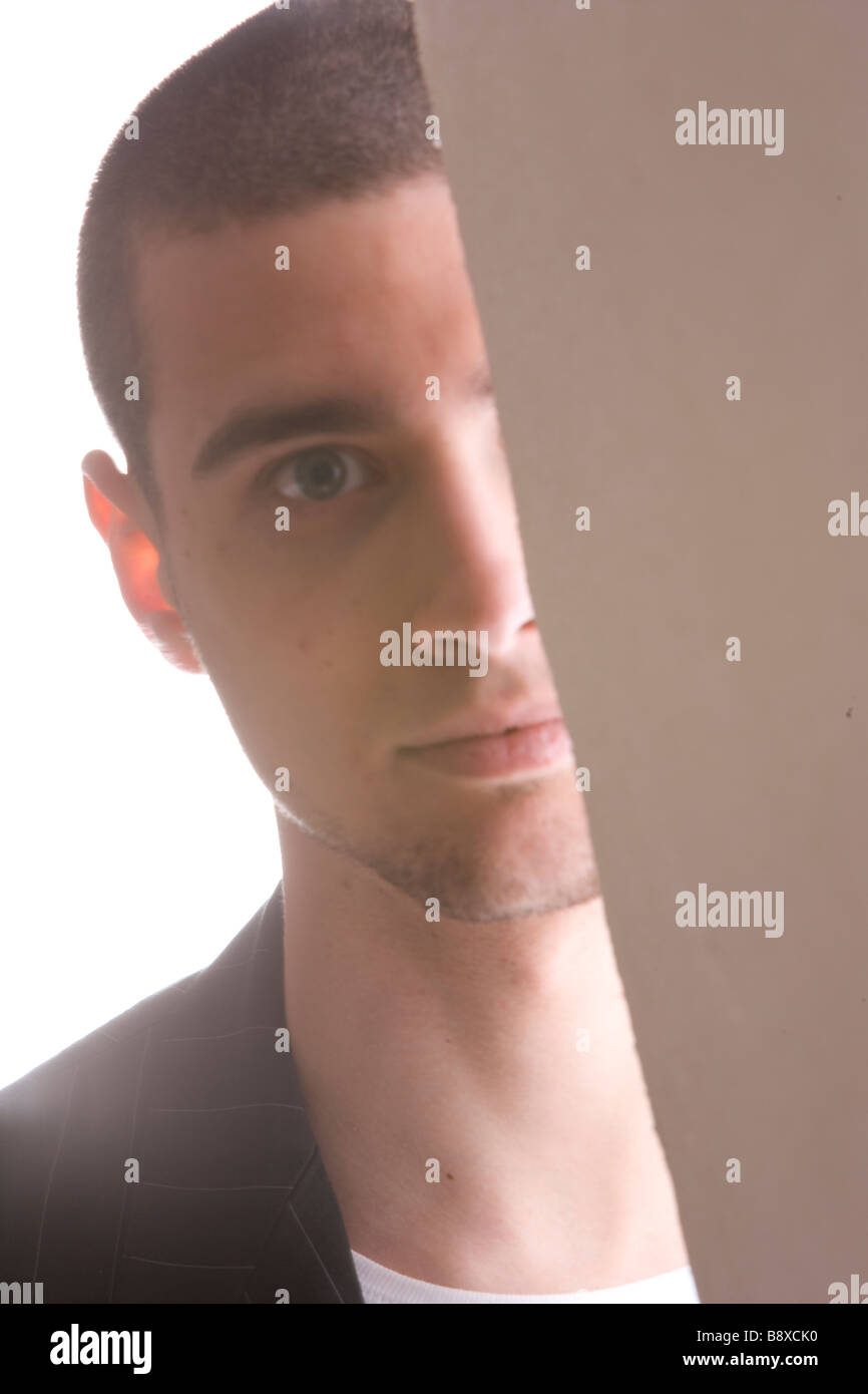 man looks at camera from behind screen with white background Stock ...