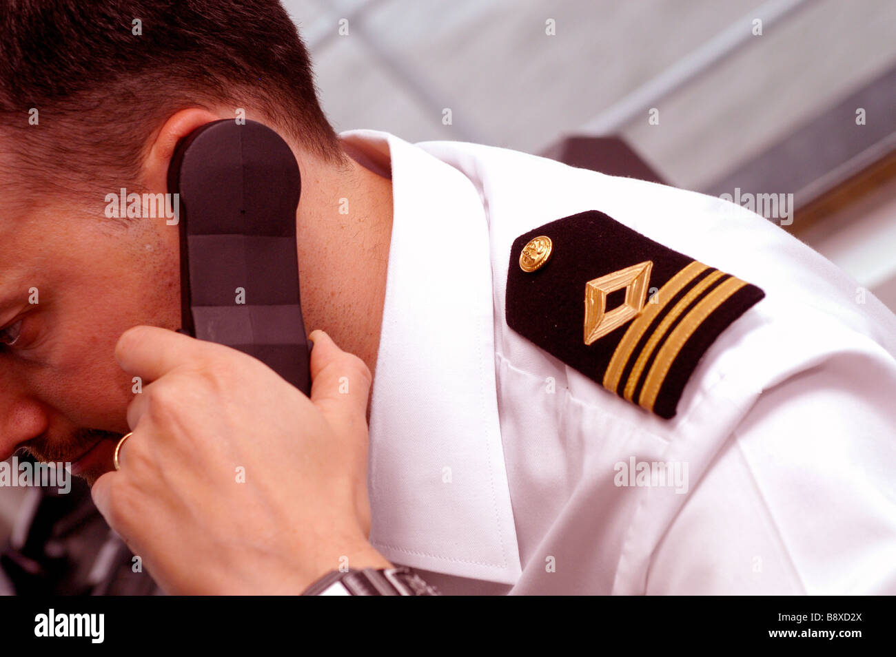 An officer of the Royal Fleet Auxiliary uses a radio telephone on the ...