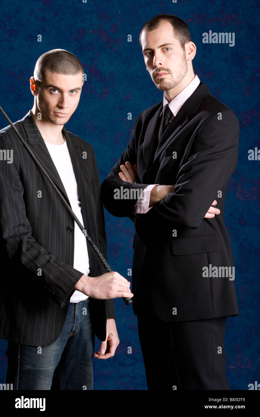 two men looking menacing at camera against blue background Stock Photo ...