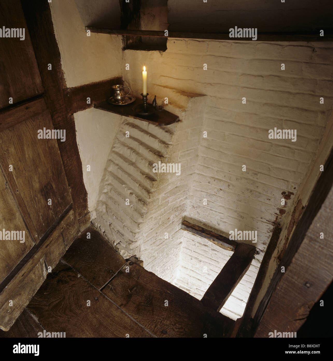 Priests hole in the Kings Room at Moseley Old Hall. A candle lights up ...