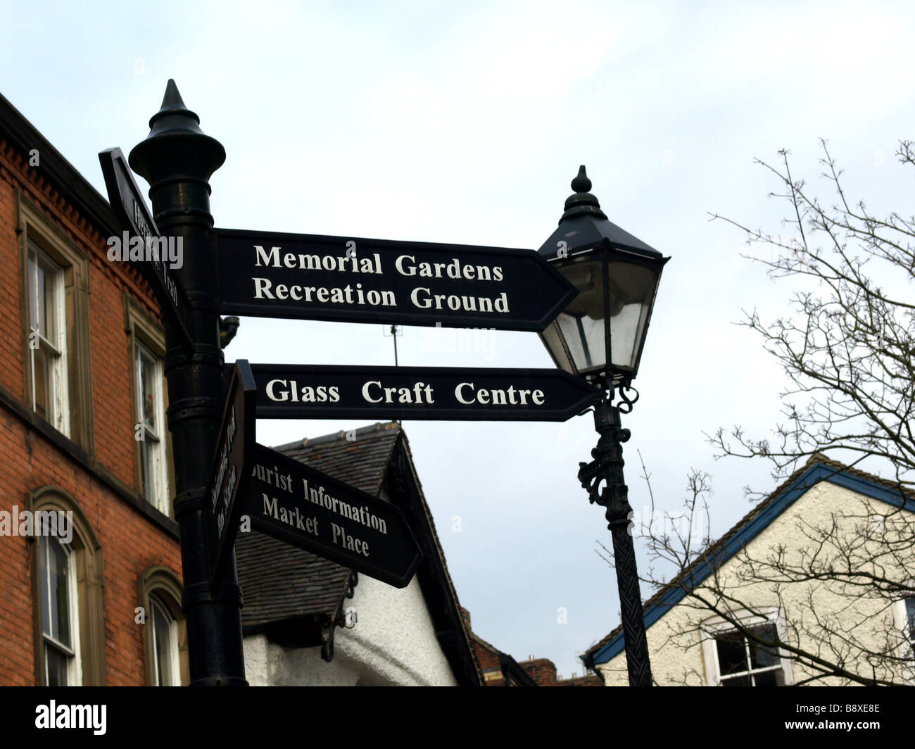 signpost with directions and gas lamp,Ashbourne,Derbyshire Stock Photo ...