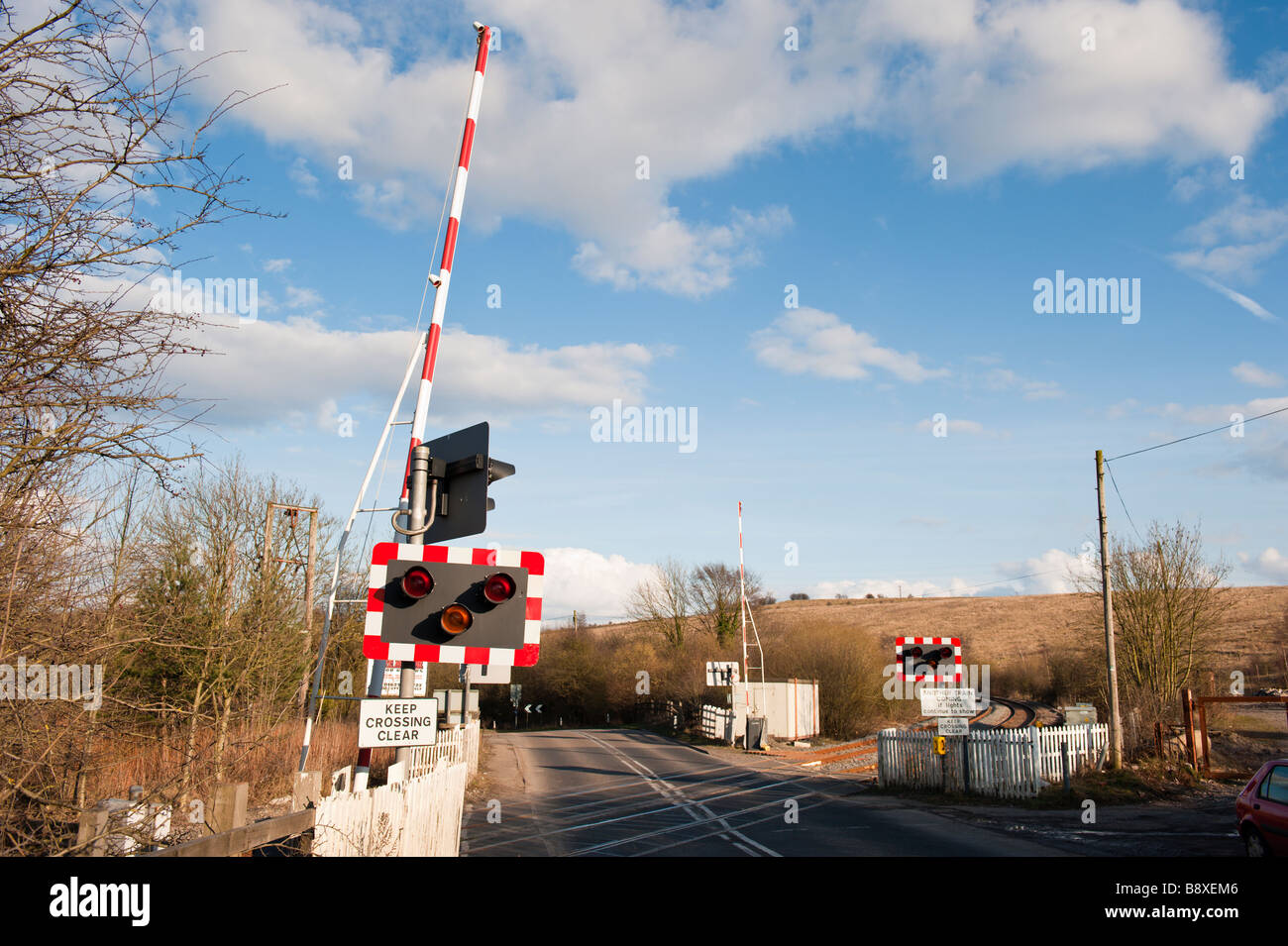Railway crossing at the junction of a train track and road. Kirkby In ...