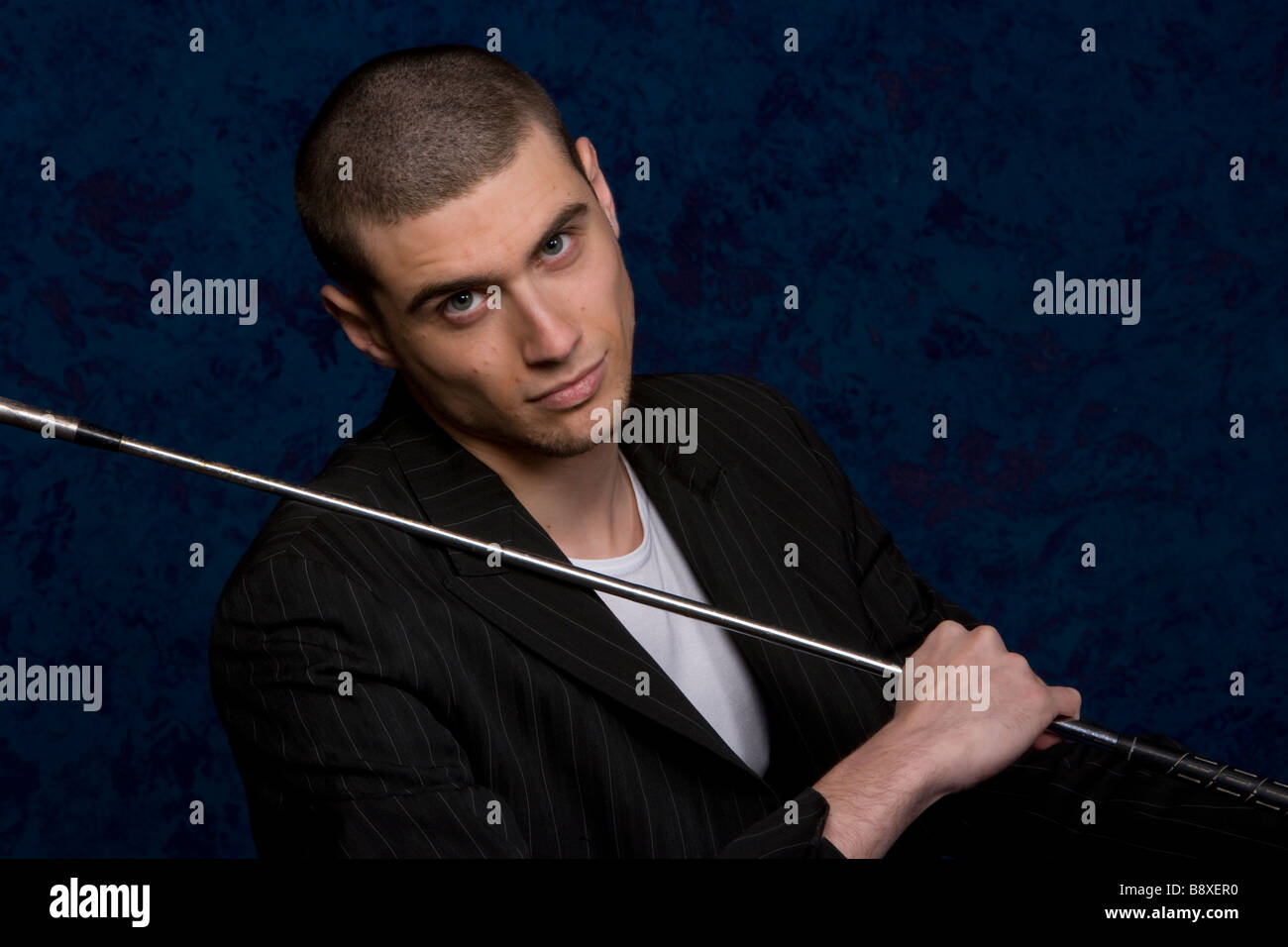 man looking menacing at camera against blue background Stock Photo - Alamy