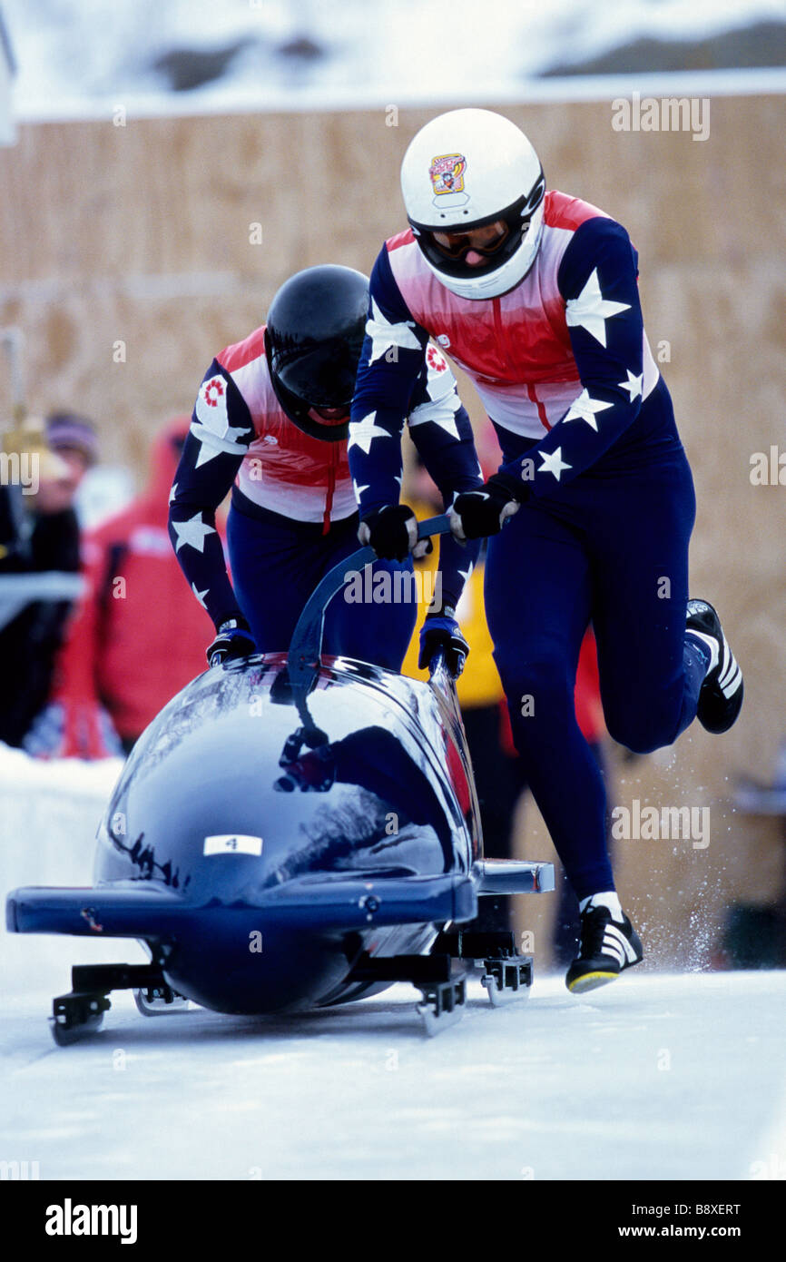 Two man bobsled team pushing off at the start Stock Photo - Alamy