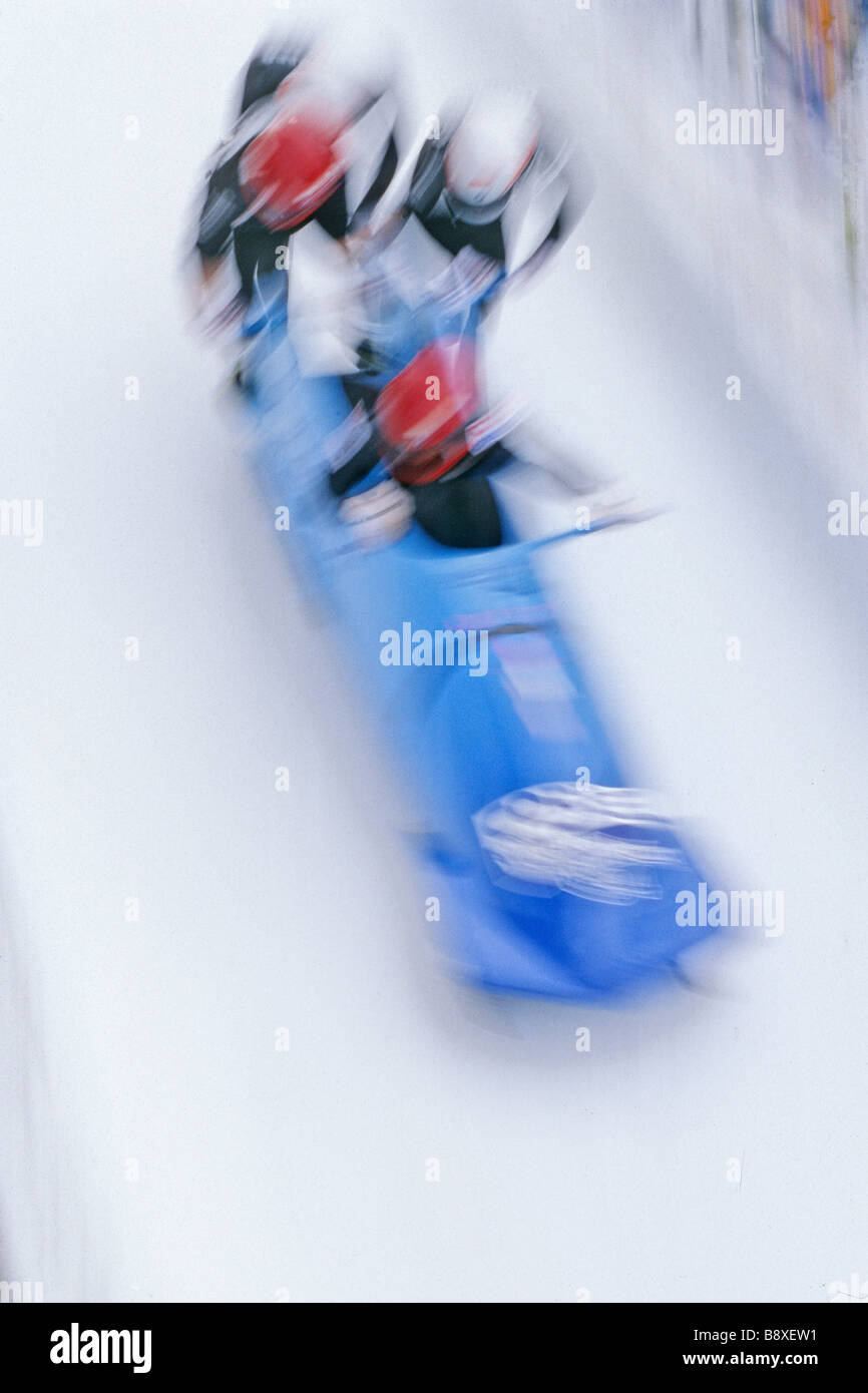 Blurred action of 4 man bobsled team pushing off at the start Stock ...