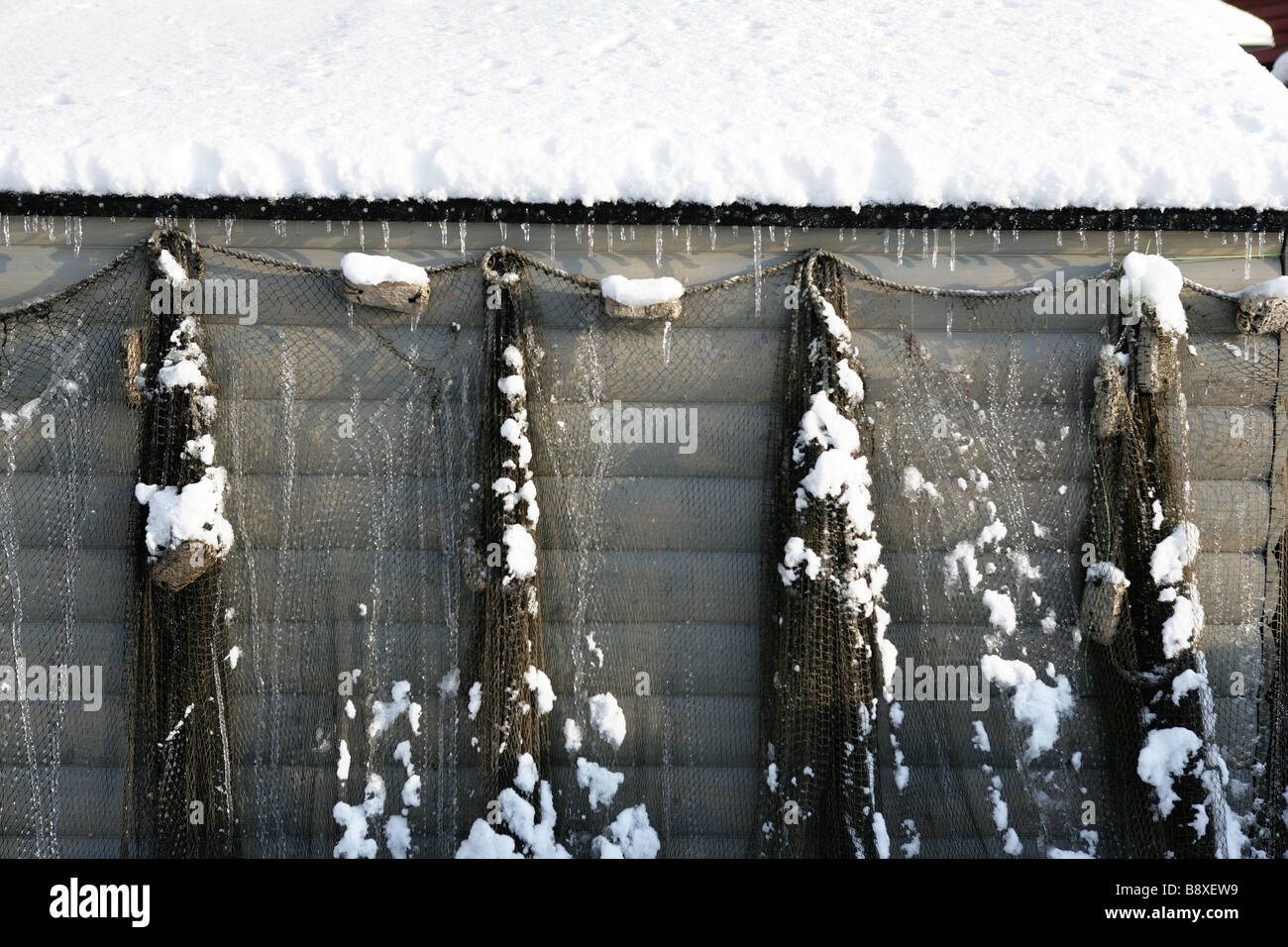 Snowy fishnet on the wall Stock Photo - Alamy