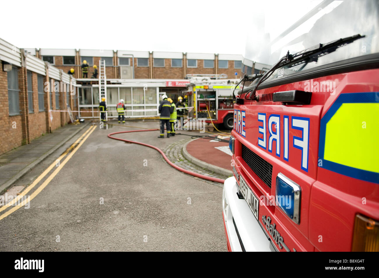 Firemen and fire engine at school on fire Stock Photo - Alamy
