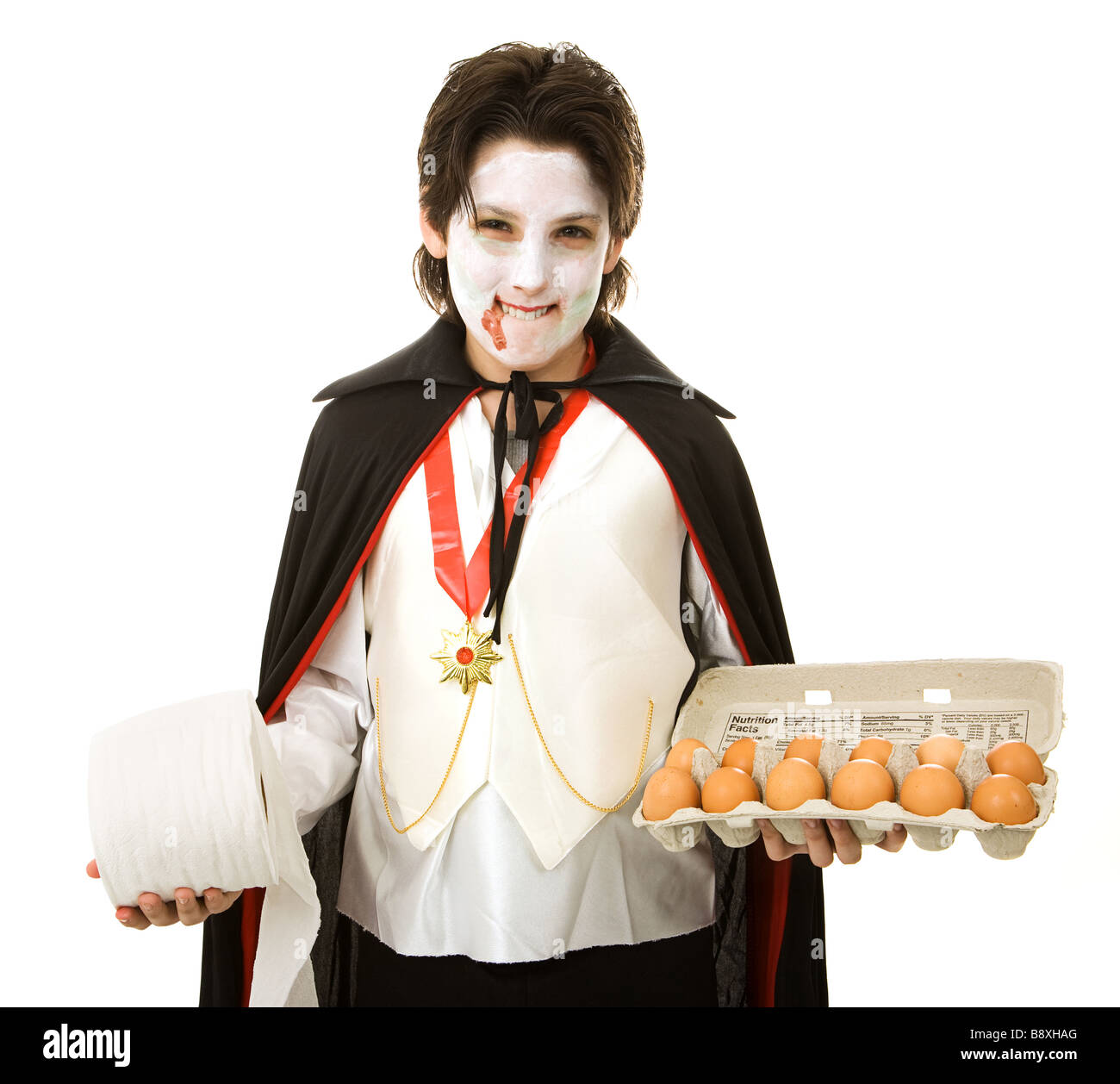 Mischievous adolescent boy ready to play halloween tricks with eggs and ...
